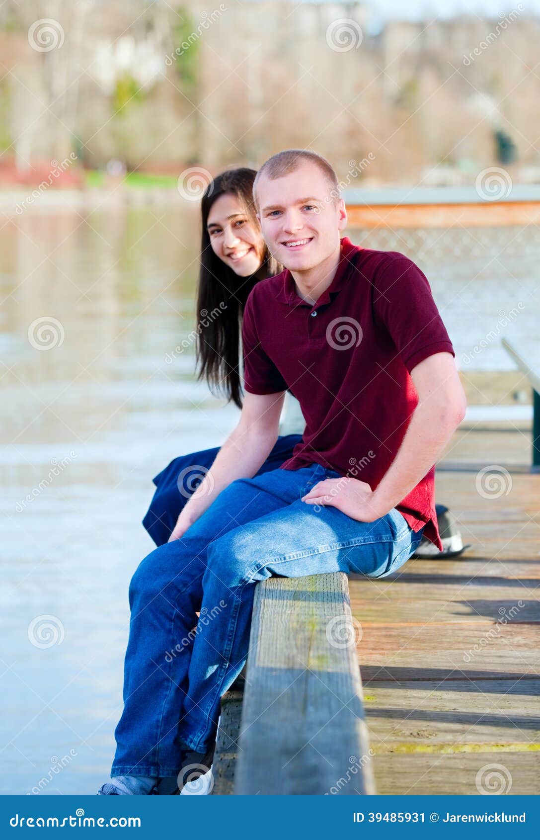 Beautiful Interracial Couple Sitting On Wooden Dock Over Lake Stock Image Image Of Adults