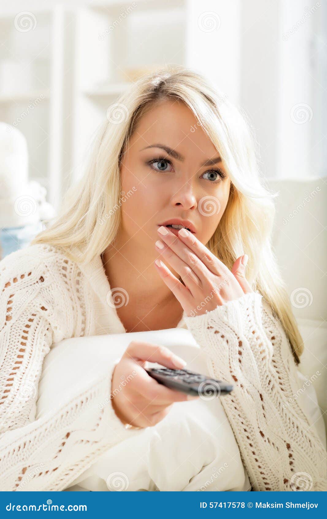 Beautiful Intrigued Woman Watching TV Using Remote Control Stock Photo ...