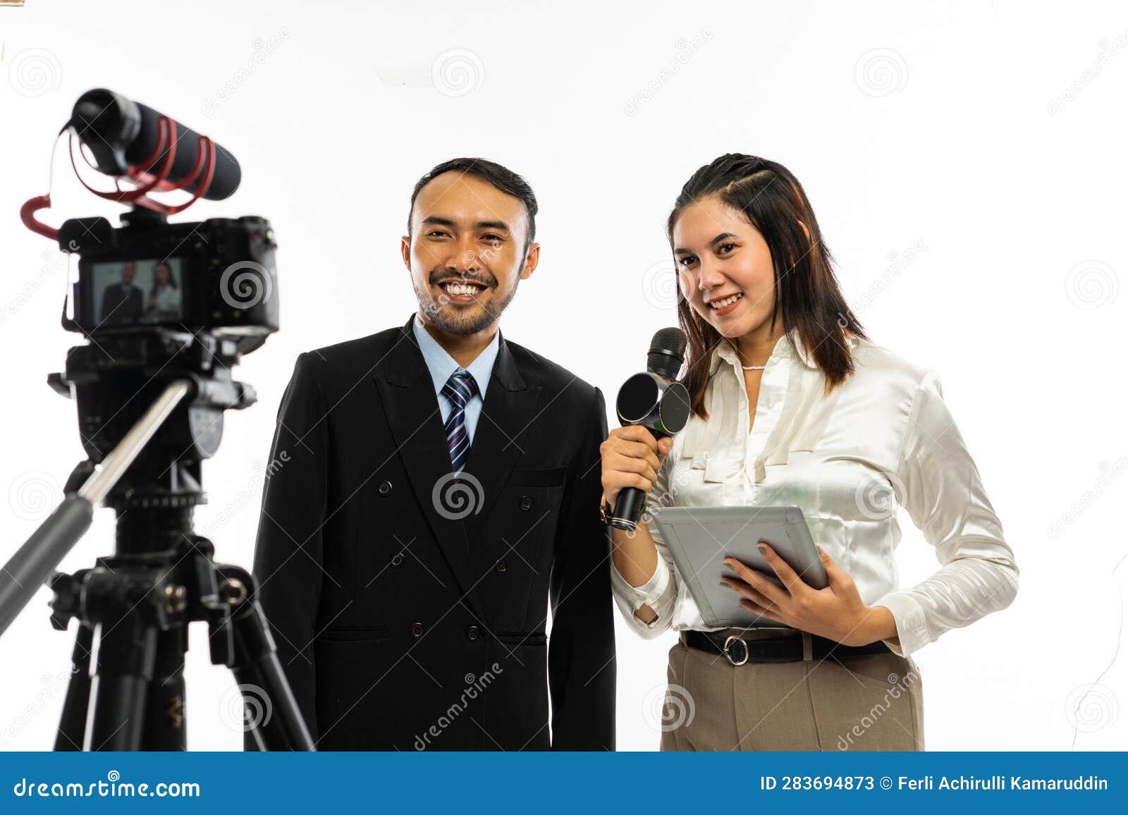 A Beautiful Journalist Talking To the Camera Using a Microphone Stock ...