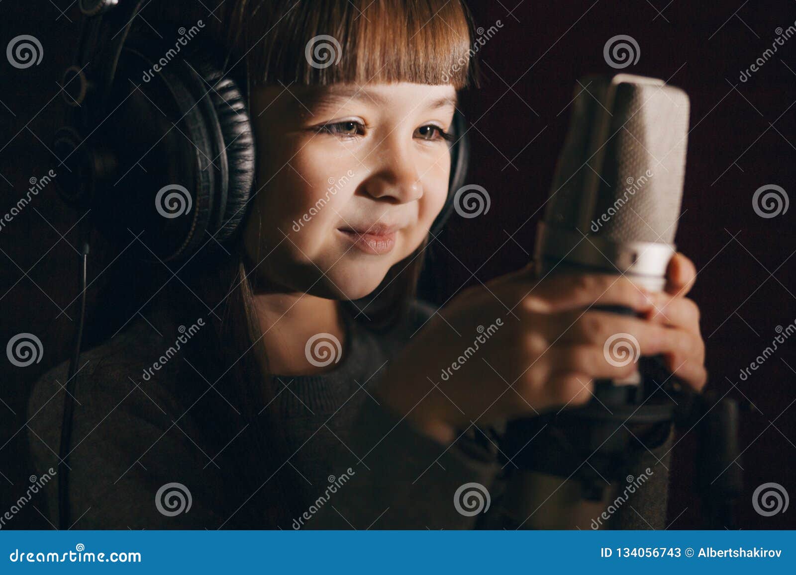 Beautiful Kid Holding the Microphone in Her First Performance Stock ...