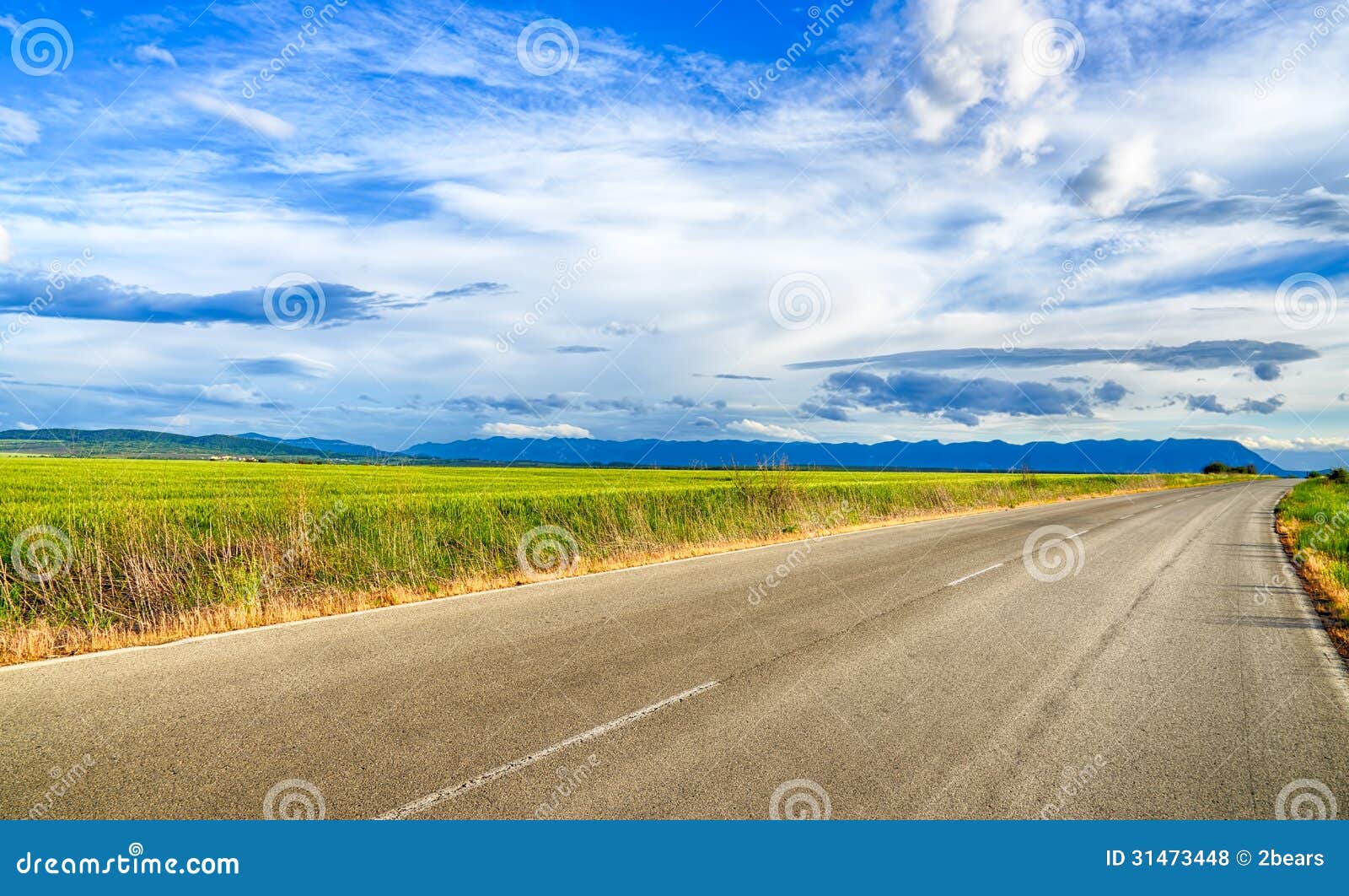 Beautiful Landscape Field of Wheat, Road, Clouds and Mountains Stock ...