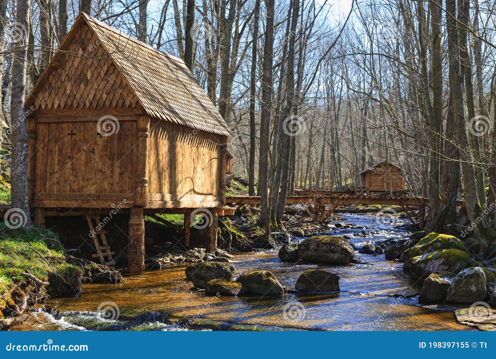 Beautiful Log Cabins by a Stream in the Forest and Footbridge Over the ...