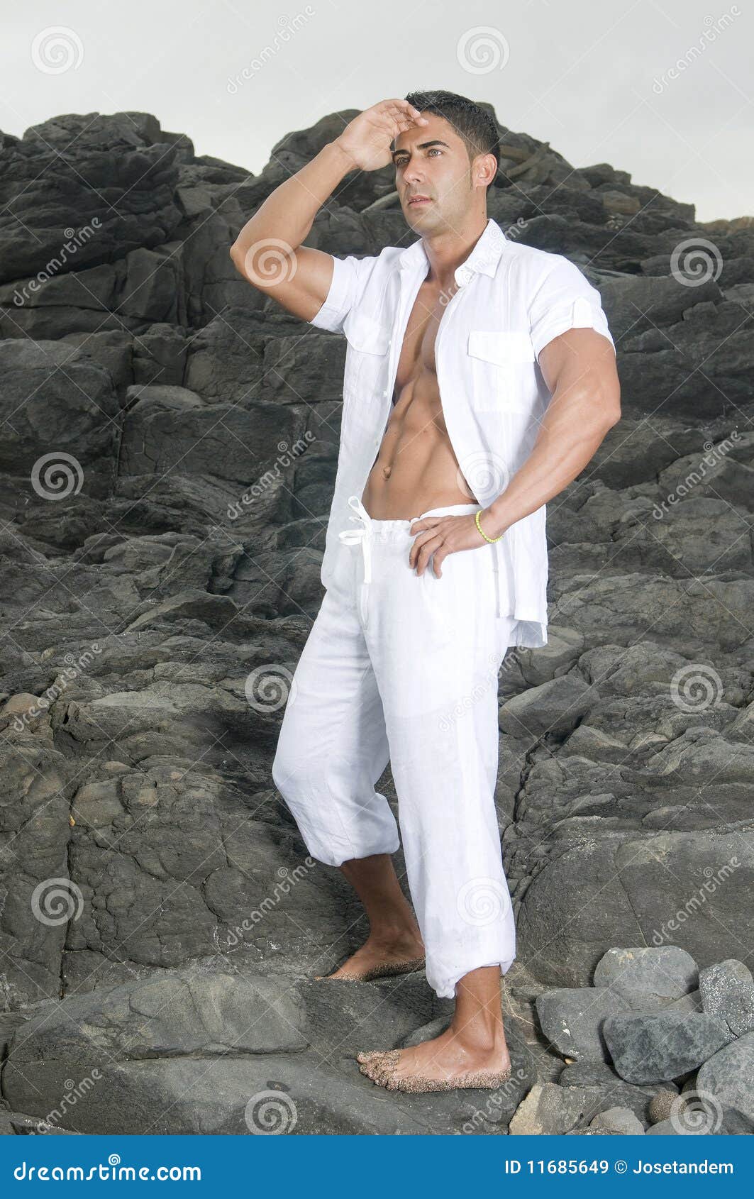Beautiful man on the rocks stock image. Image of isolated - 11685649