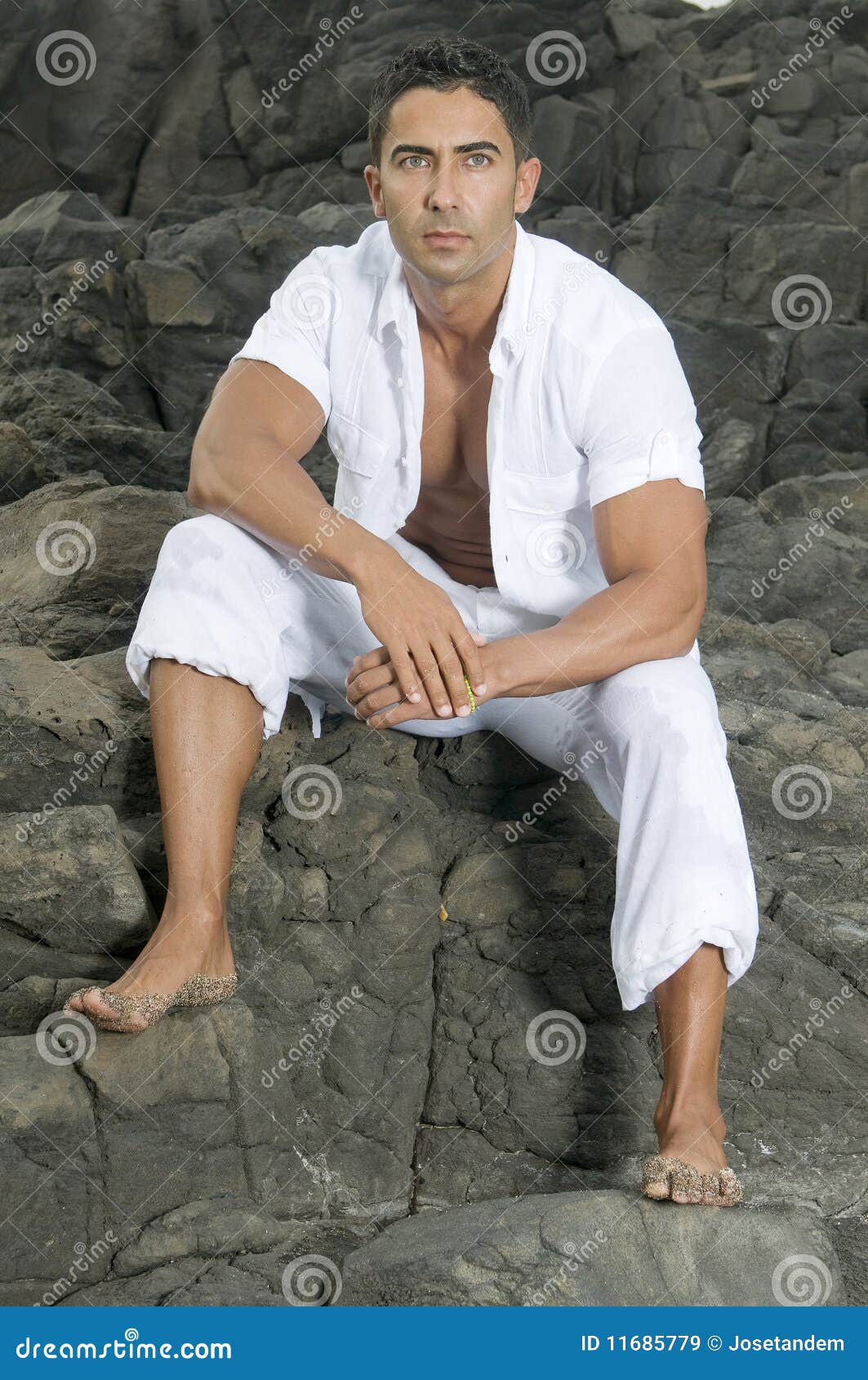 Beautiful man on the rocks stock image. Image of male - 11685779
