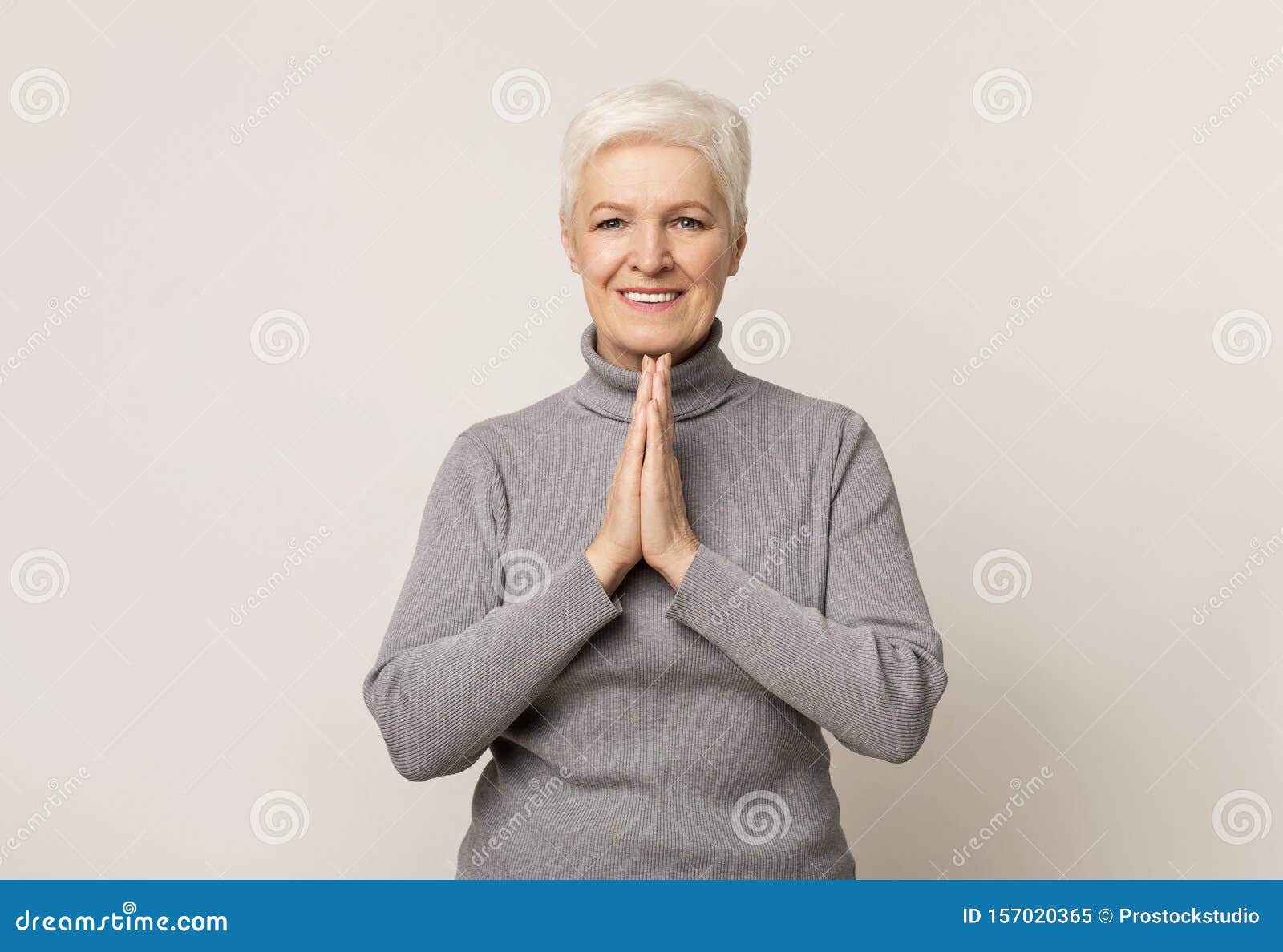 Beautiful Mature Woman Pleading For Something With Clasped Hands Stock