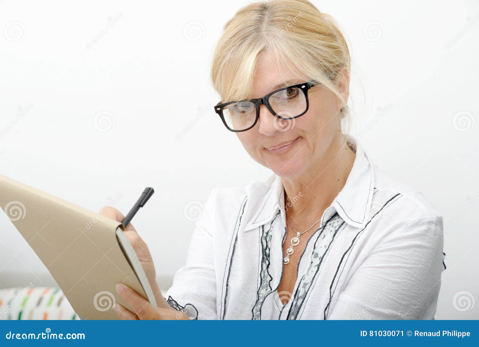 Beautiful Mature Woman Writing on a Notebook Stock Image - Image of ...