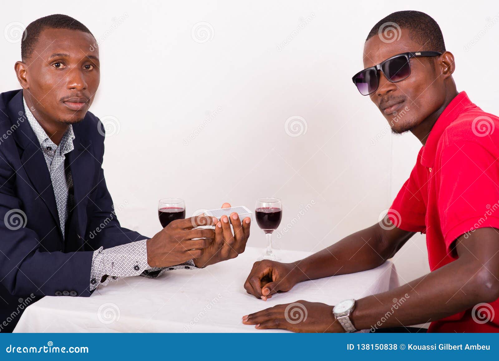Beautiful Men Sitting Around the Table in Front of Glasses of Wine ...