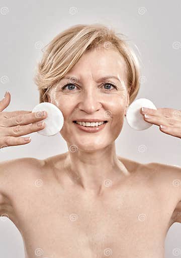 Beautiful Middle Aged Woman With Flawless Skin Smiling At Camera While