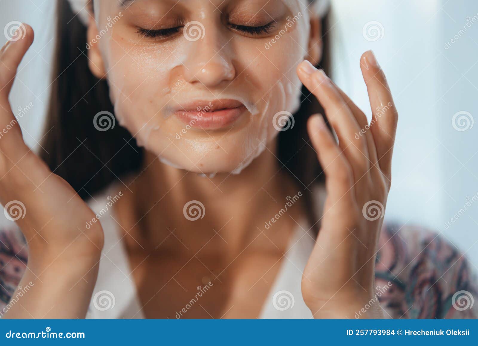 Beautiful Model Applying Cosmetic Cream Treatment On Her Face Stock