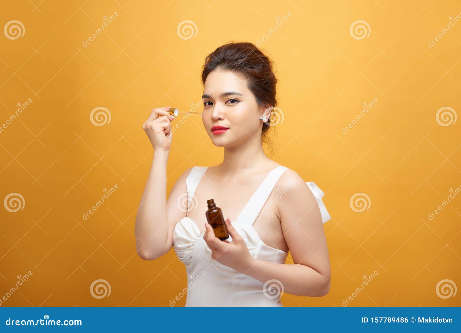 Beautiful Model Applying a Cosmetic Skin Serum on Her Skin Stock Photo ...