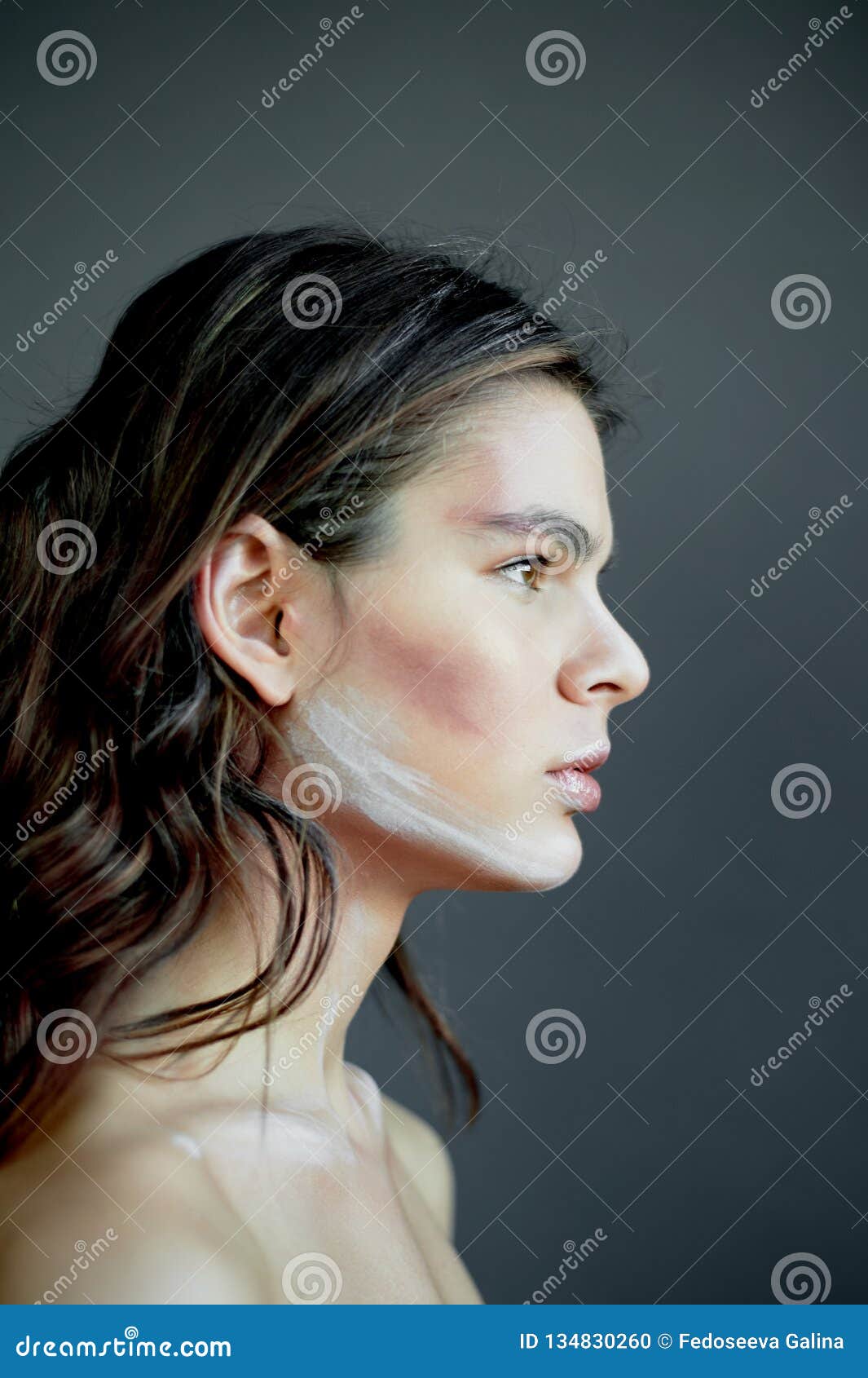 Beautiful Model. Stands in Profile, Makeup with Paint Strokes on the ...