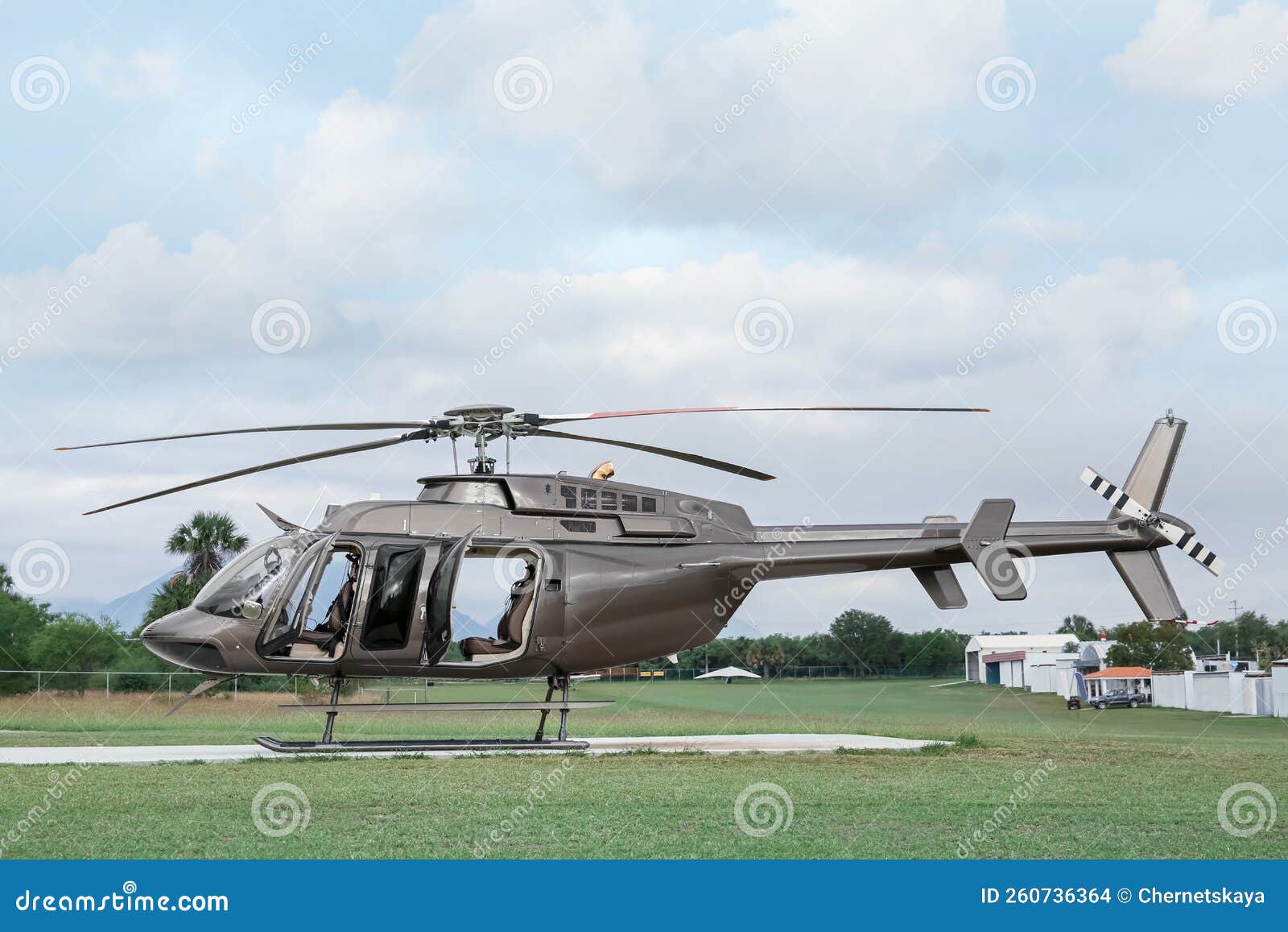 Beautiful Modern Helicopter on Helipad in Field Stock Photo - Image of ...