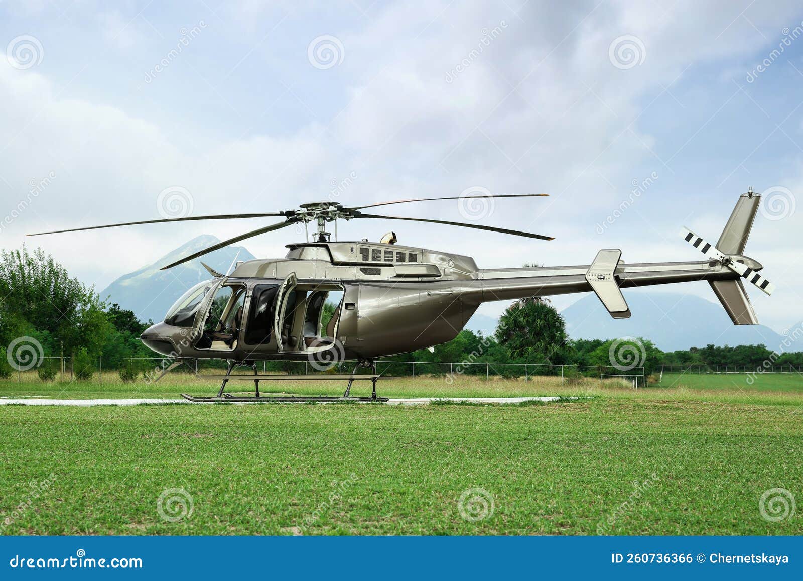 Beautiful Modern Helicopter on Helipad in Field Stock Photo - Image of ...