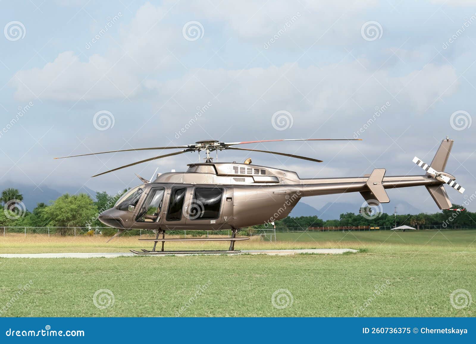 Beautiful Modern Helicopter on Helipad in Field Stock Image - Image of ...