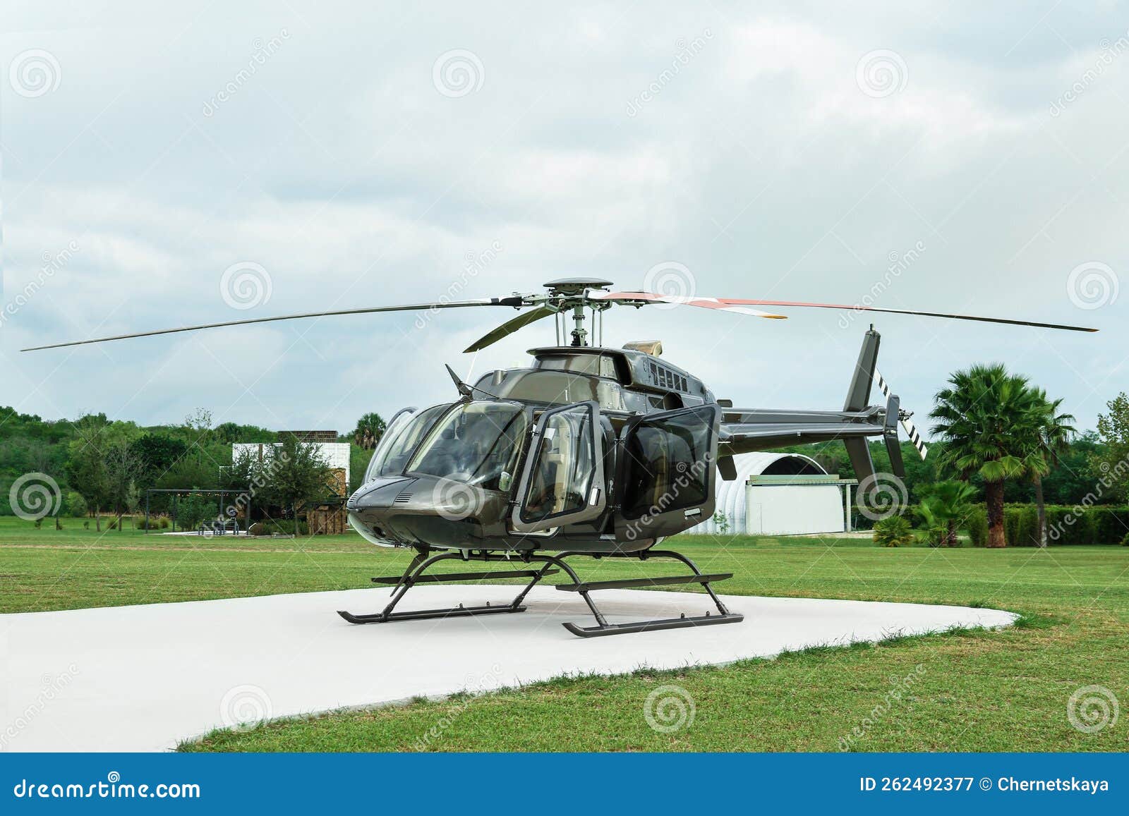 Beautiful Modern Helicopter on Helipad in Field Stock Image - Image of ...
