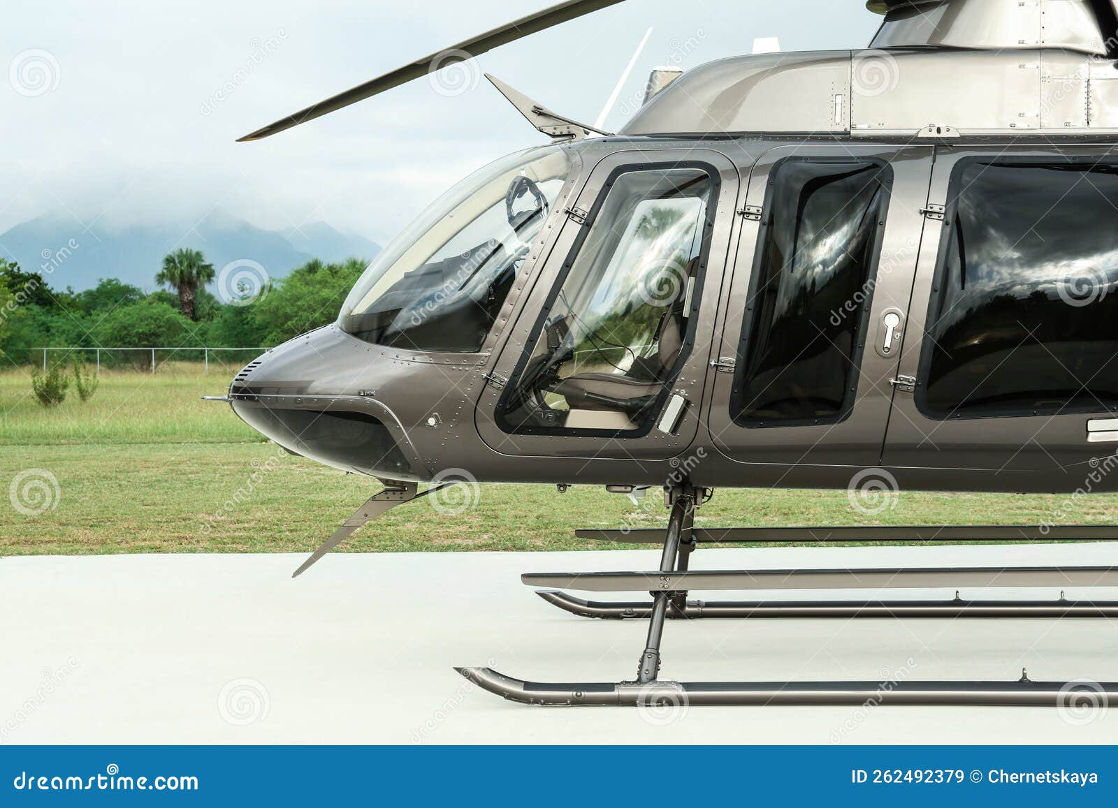 Beautiful Modern Helicopter on Helipad in Field Stock Image - Image of ...