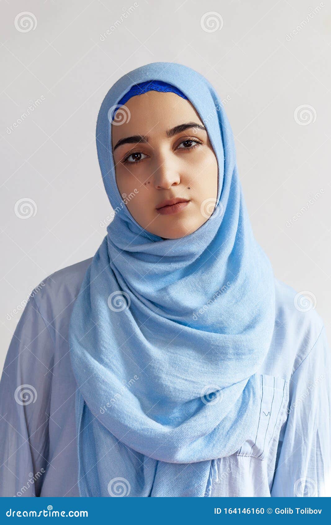 Beautiful Muslim Woman in Hijab Against White Background. Portrait of ... Beautiful Muslim Woman in Hijab Against White Background. Portrait of ...