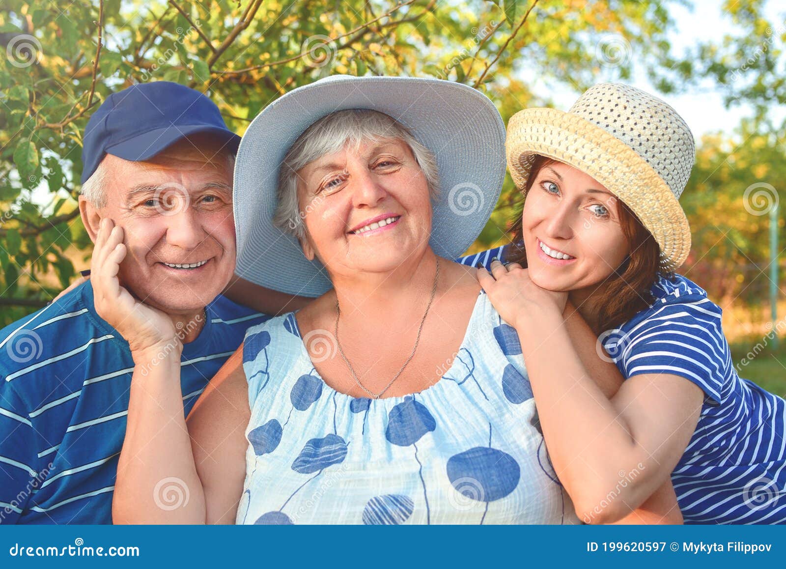 Beautiful Old Couple Is Sitting On The Bench In The Park With Their