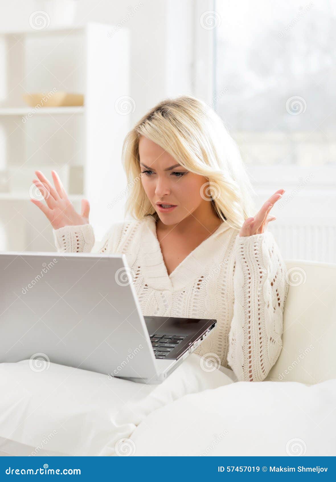 Beautiful Outraged Woman Sitting on the Sofa Using a Laptop Stock Image ...