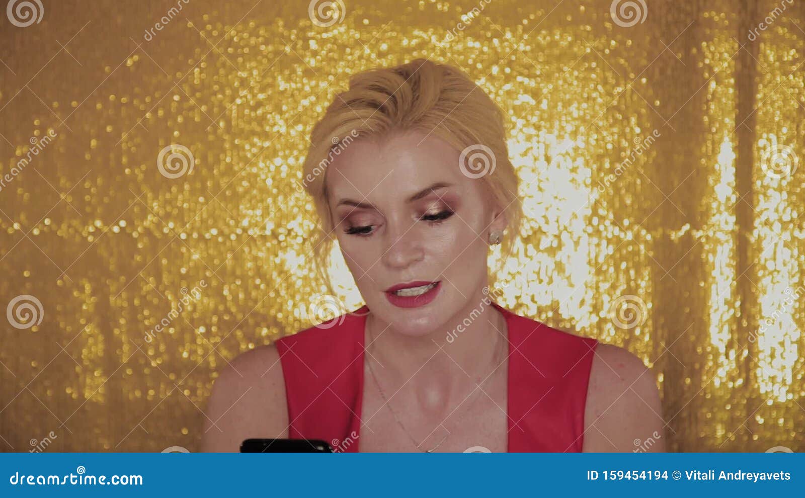 Beautiful Photo Model Posing on a Gold Background in a Photo Studio ...