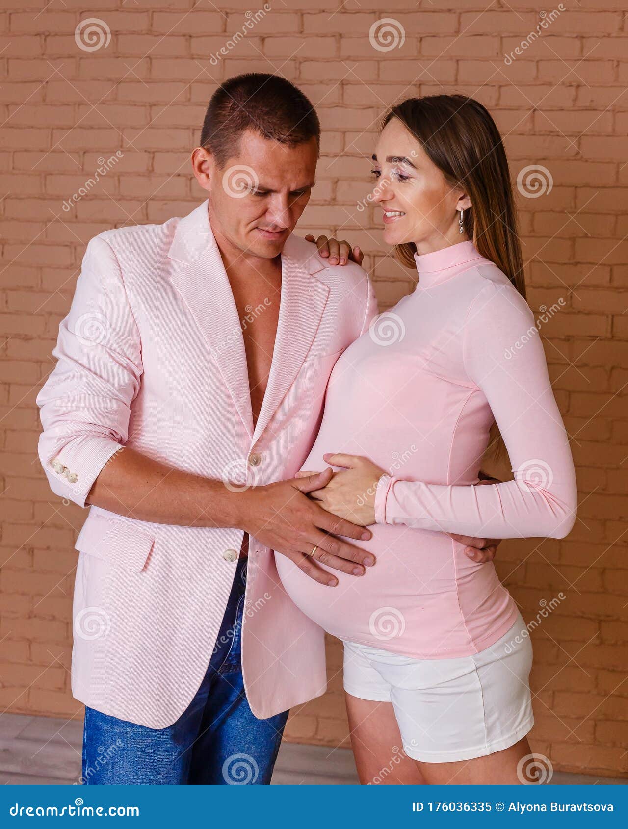 A Beautiful Pregnant Caucasian Woman With A Big Belly And A Man In A