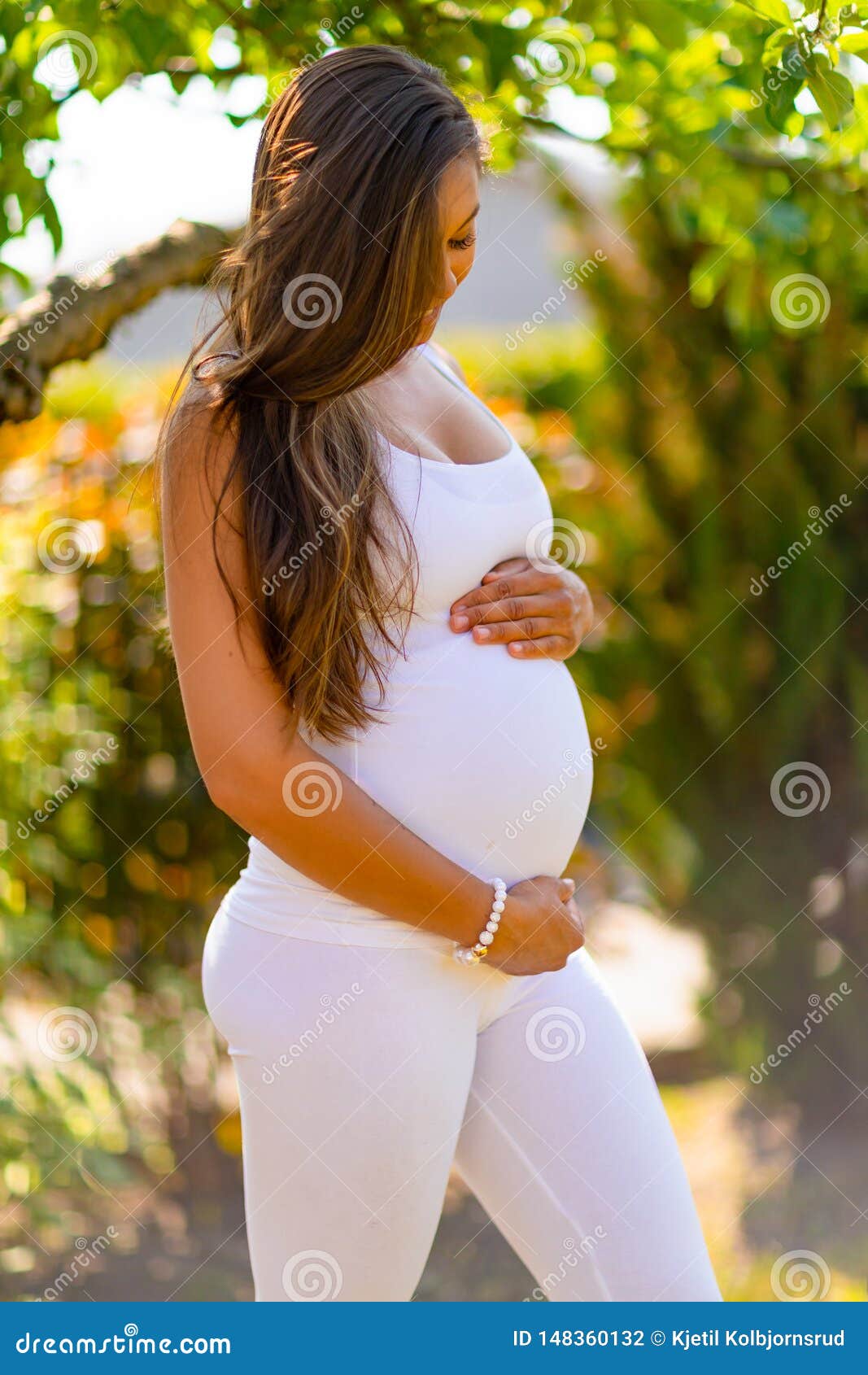 Beautiful Pregnant Woman Standing Outdoor Holding Hands On Belly Stock
