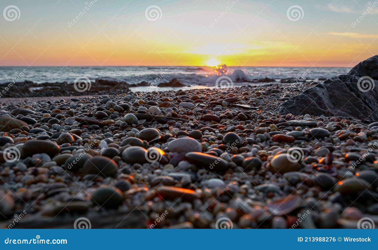 Beautiful Quiet and Calm Beach during an Orange Sunset Stock Photo ...