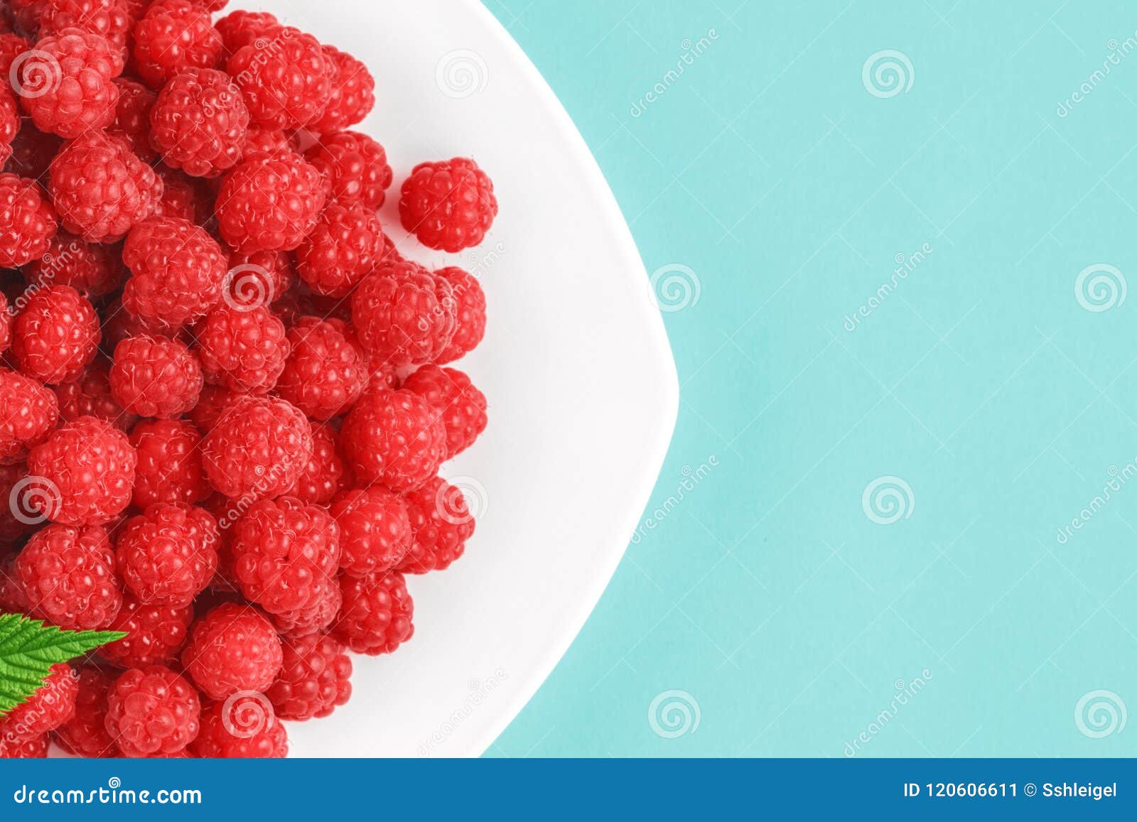 Beautiful Raspberry in a White Plate Top View, Blue Background Stock ...