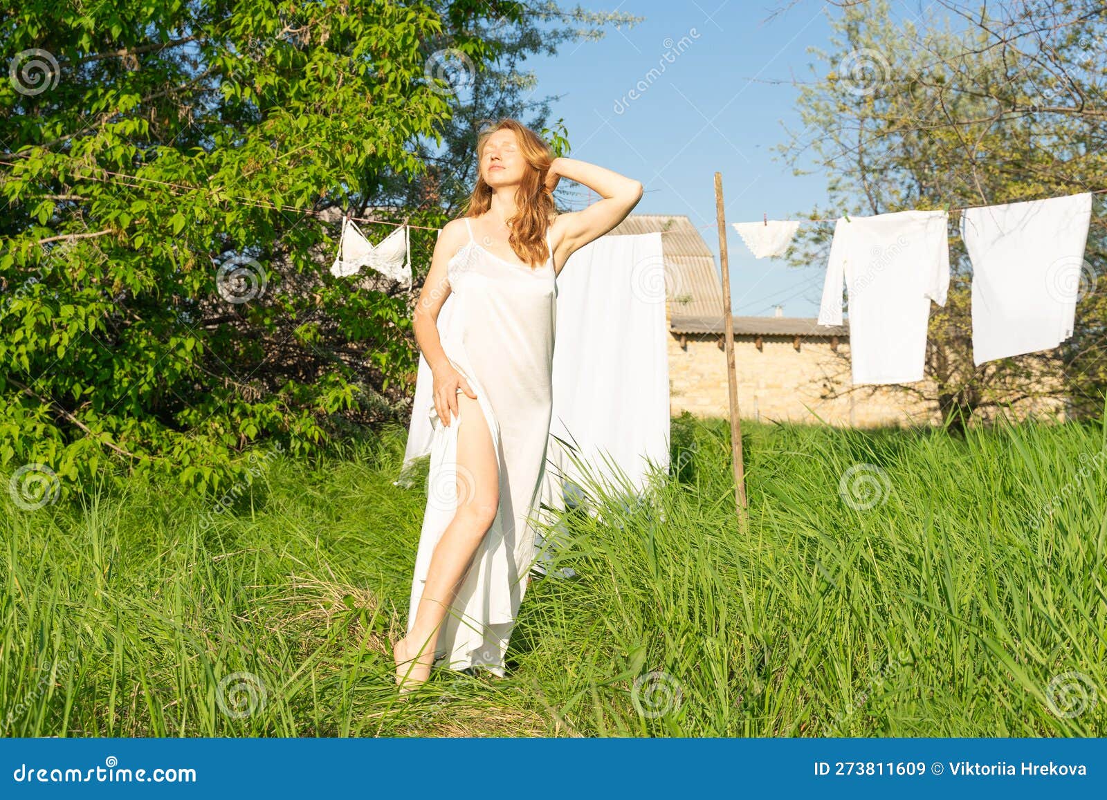 Beautiful Red Girl In Nightie Hanging Laundry Outdoors Village Woman
