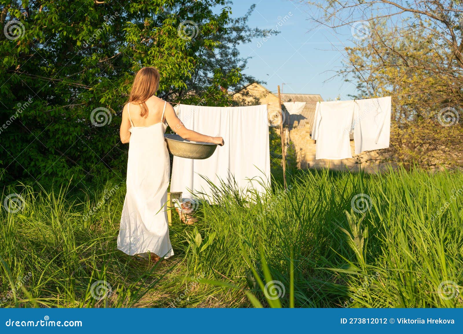 Beautiful Red Girl In Nightie Hanging Laundry Outdoors Village Woman