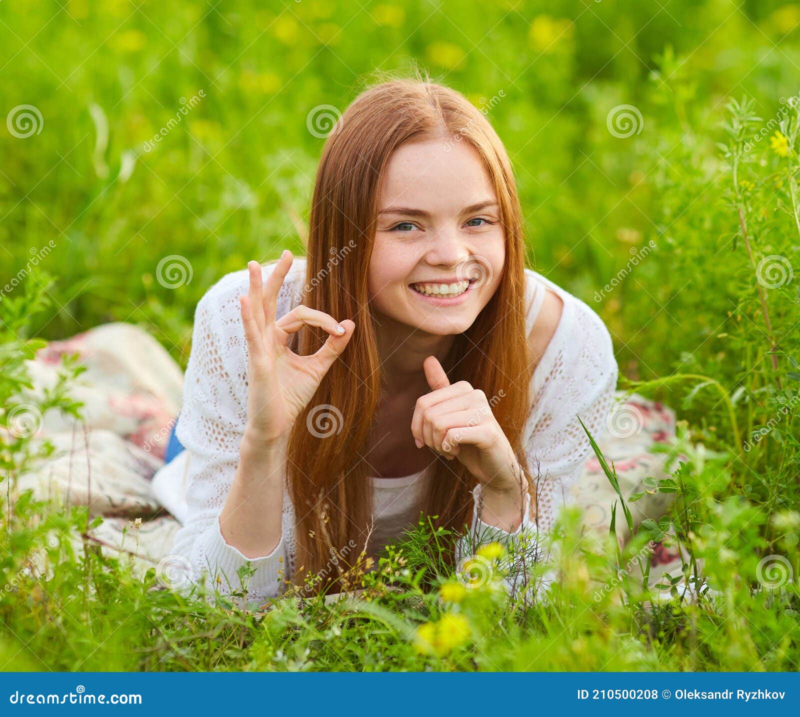 Beautiful Red Hair Woman Lying On Grass At The Park On Summer Day Stock