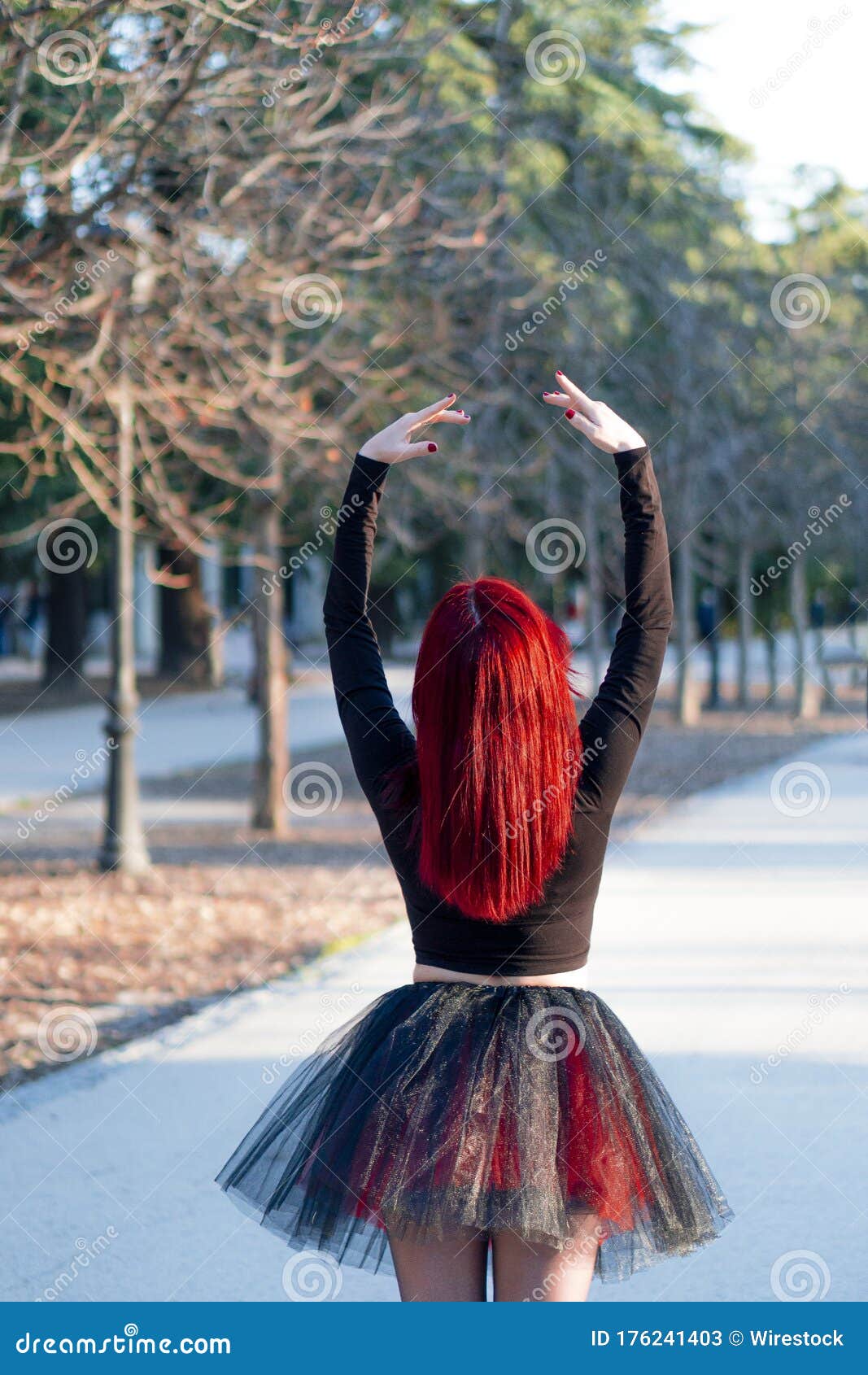 Beautiful Red Haired Ballerina Gracefully Dancing at a Park with Trees ...