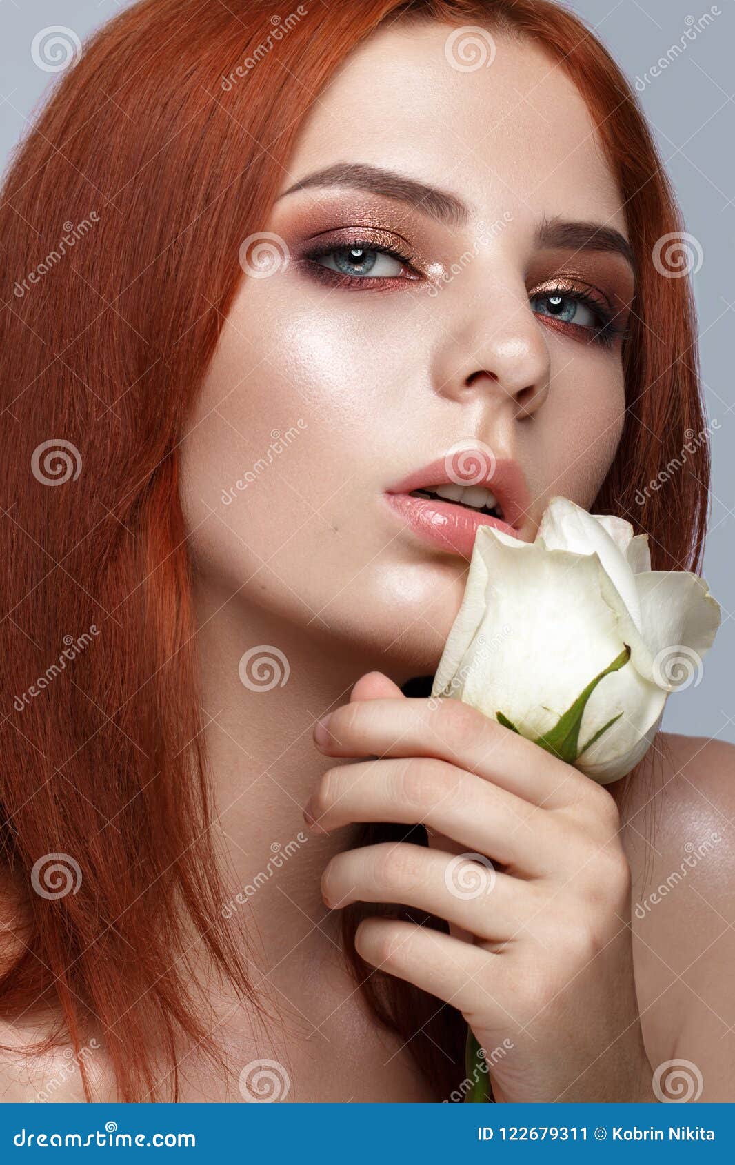 Beautiful Red Haired Girl With A Classic Make Up And Rose In Her Hands