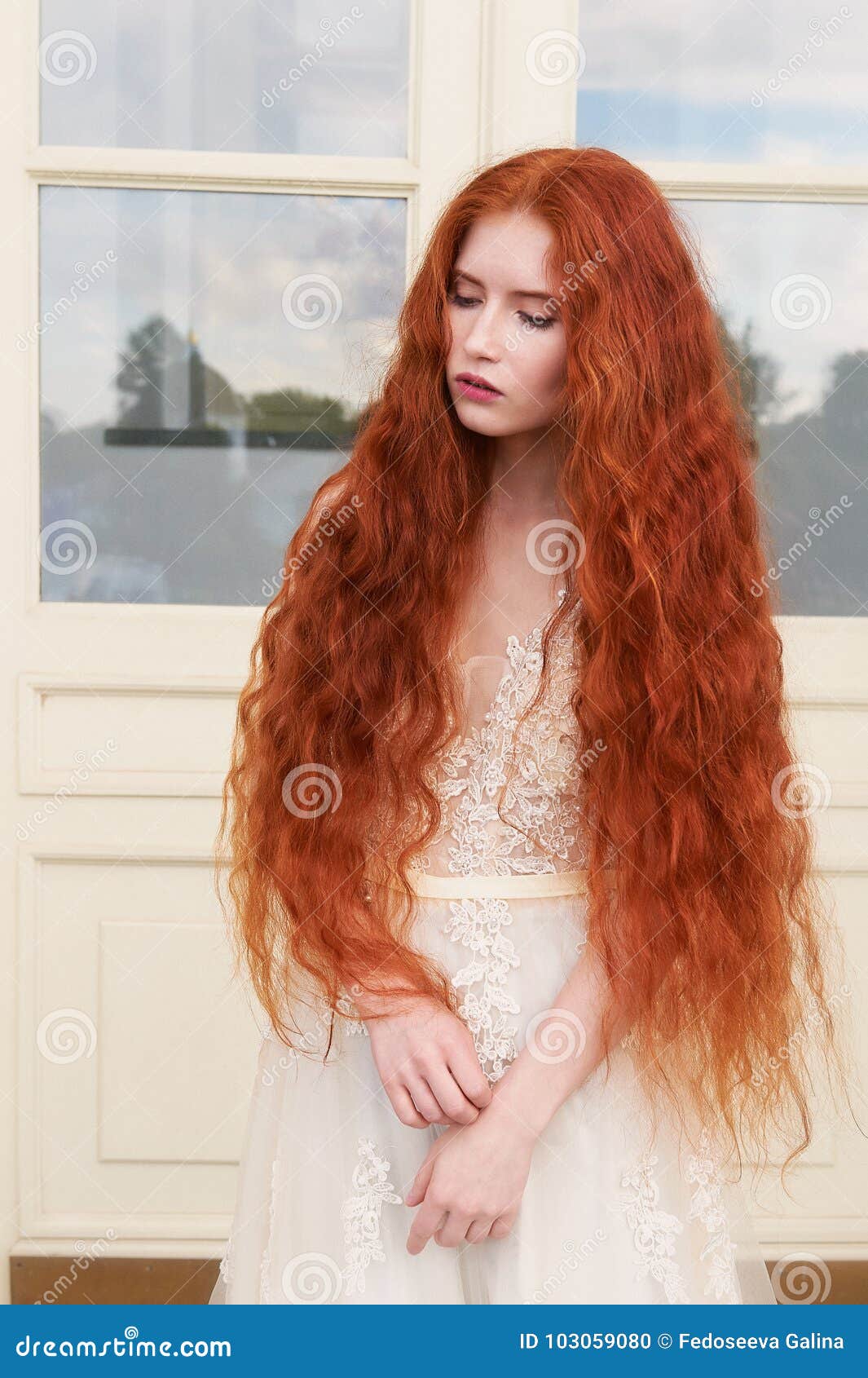 Beautiful Red Haired Girl With Long Curly Hair In The Bride In A Long