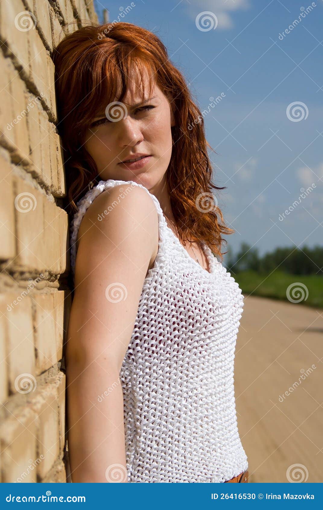 A Beautiful Red-haired Girl Standing by the Wall Stock Photo - Image of ...