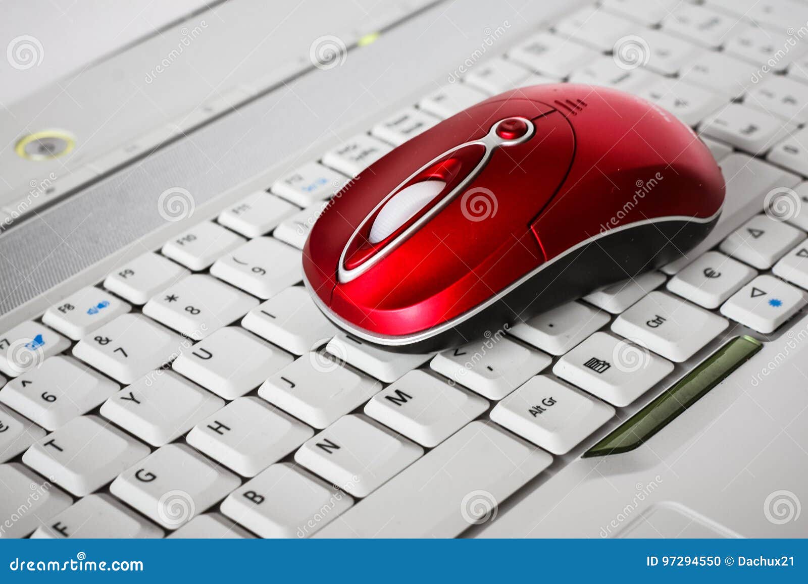 A Beautiful Red Wireless Mouse on the White Keyboard of a Laptop. Stock ...