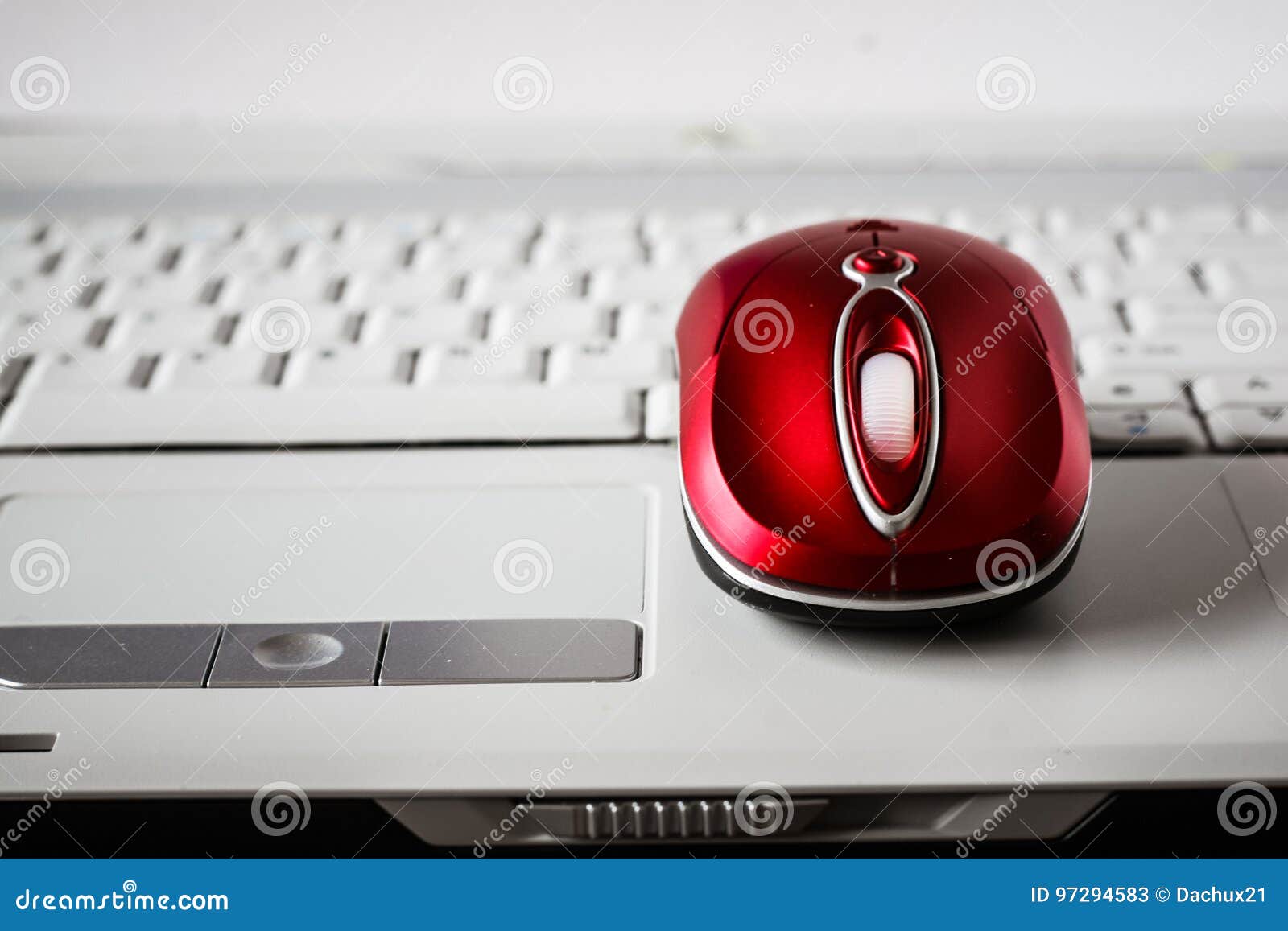 A Beautiful Red Wireless Mouse on the White Keyboard of a Laptop. Stock ...
