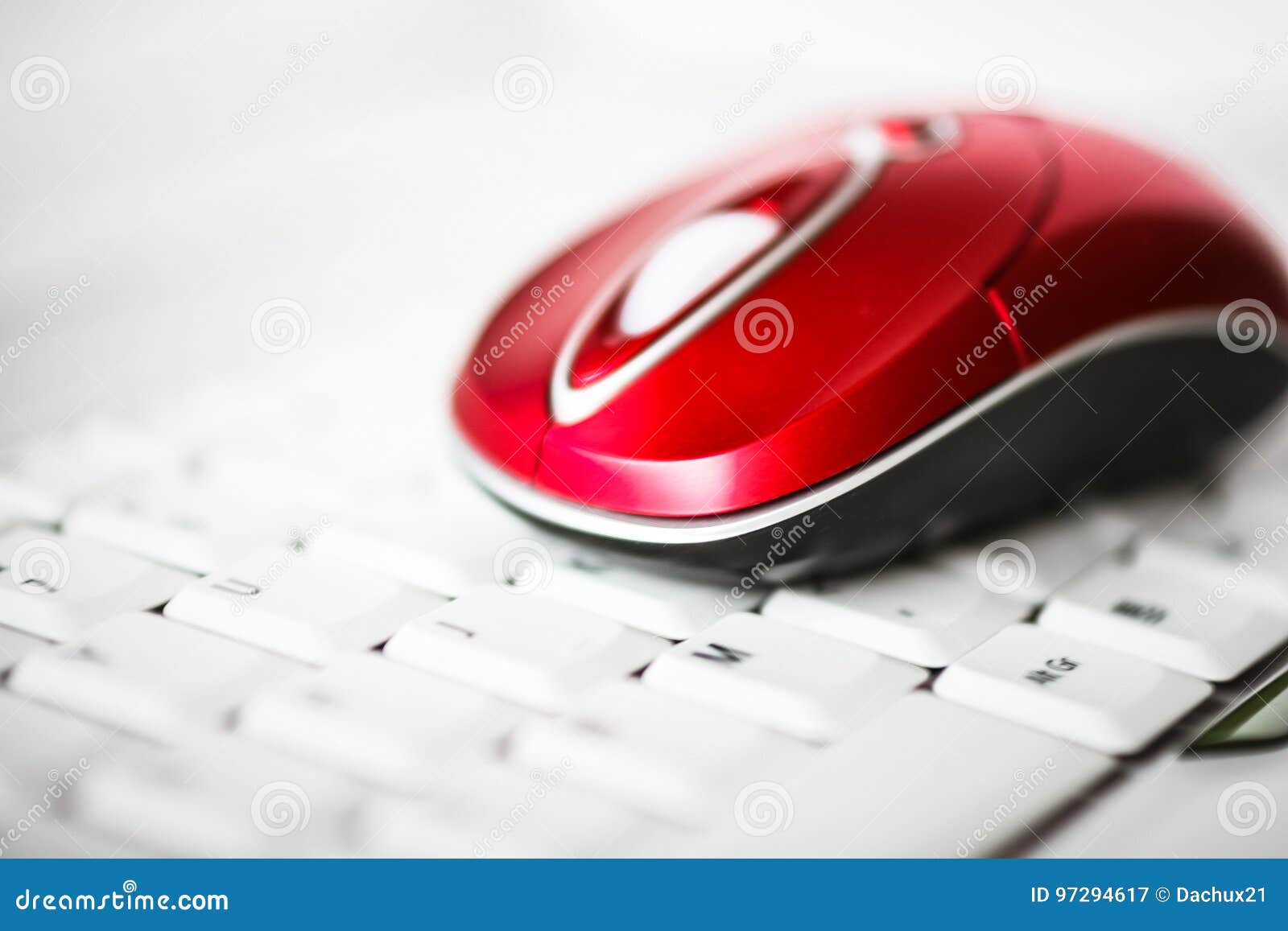 A Beautiful Red Wireless Mouse on the White Keyboard of a Laptop. Stock ...