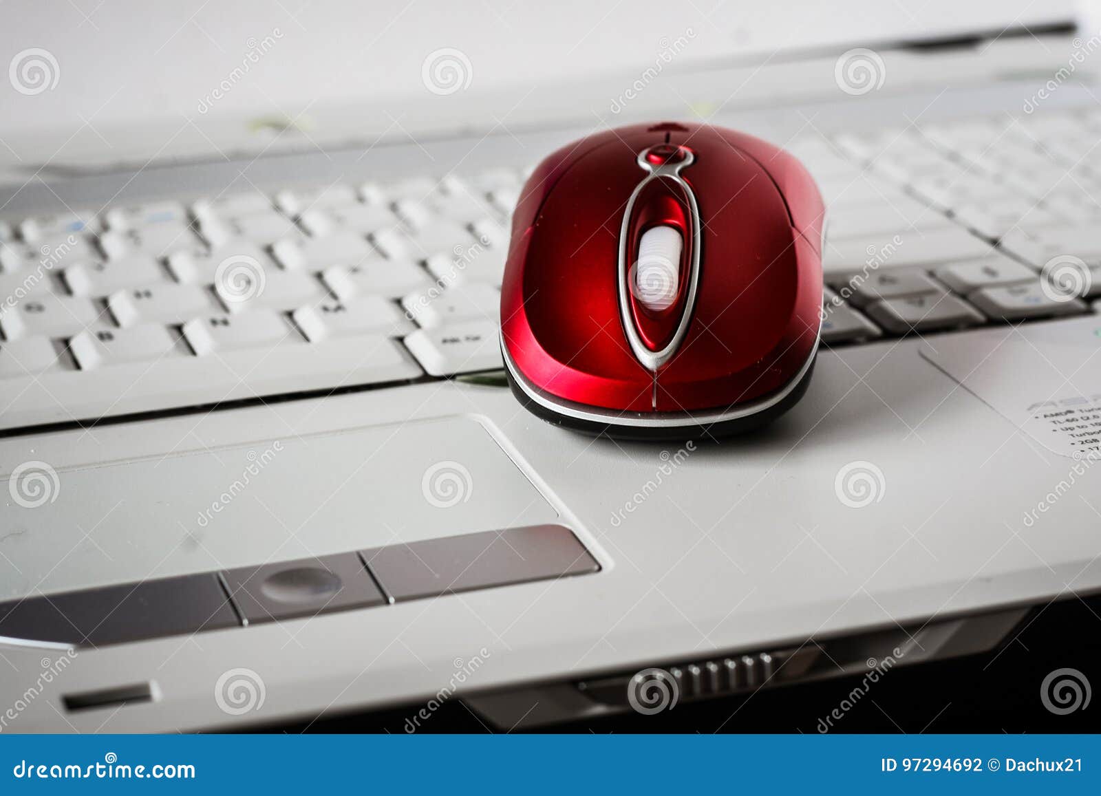 A Beautiful Red Wireless Mouse on the White Keyboard of a Laptop. Stock ...