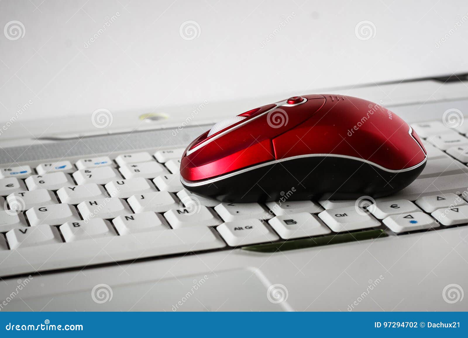A Beautiful Red Wireless Mouse on the White Keyboard of a Laptop. Stock ...