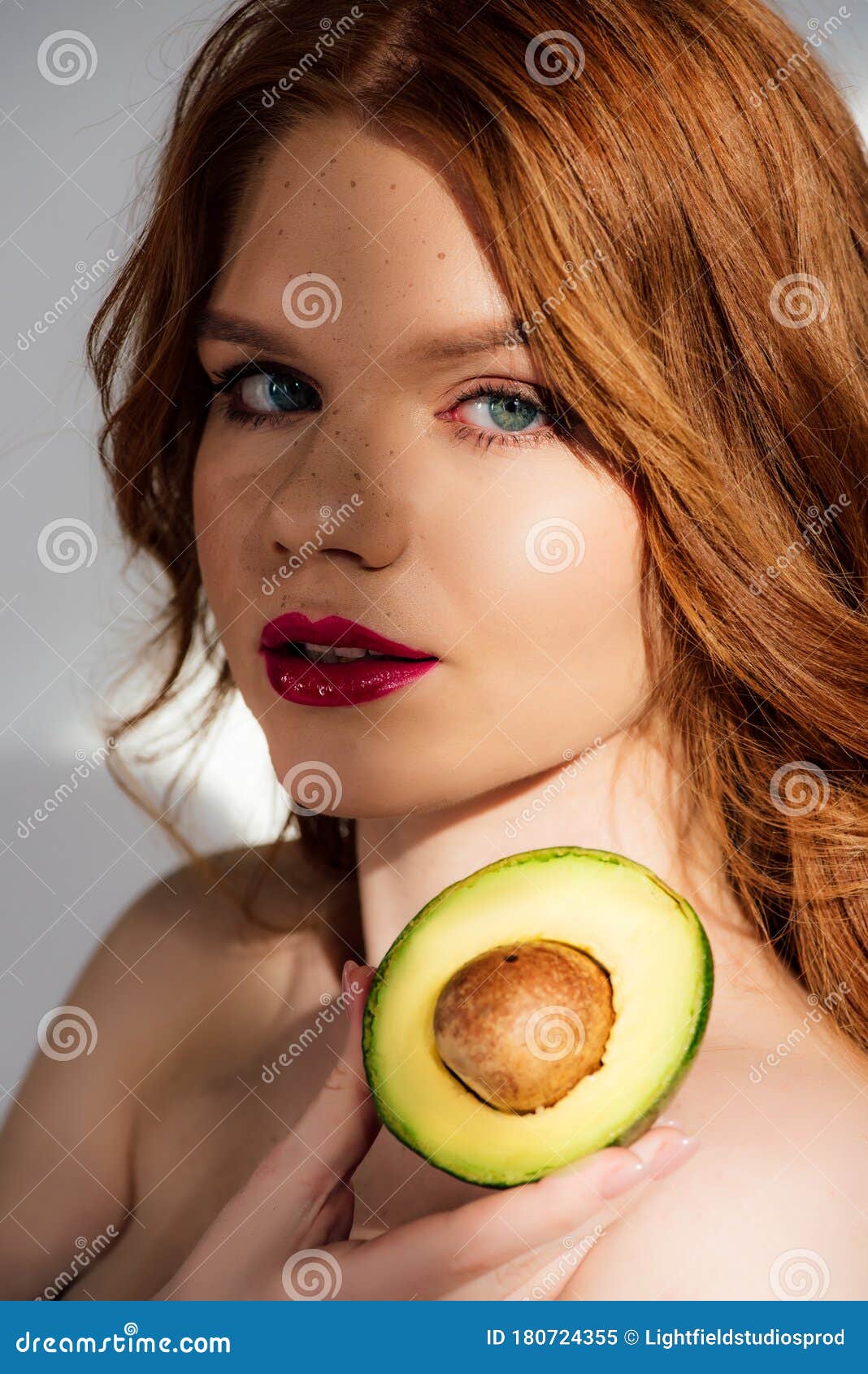 Beautiful Redhead Girl With Red Lips Looking At Camera And Posing With