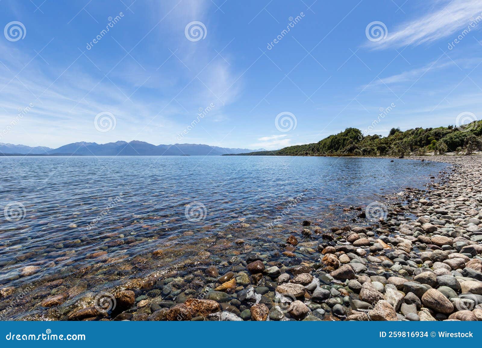 Beautiful Rocky Seashore with Mountains in the Distance Stock Photo ...