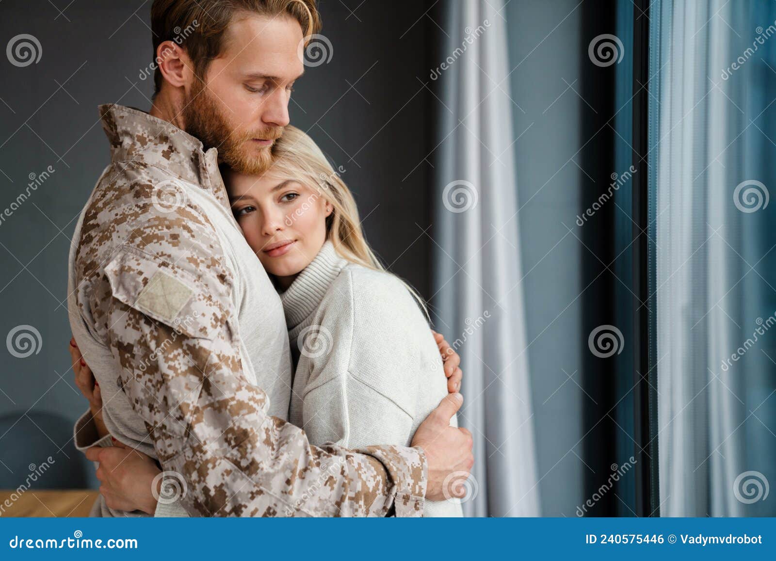 Beautiful Romantic Couple Hugging While Standing Near Window Stock