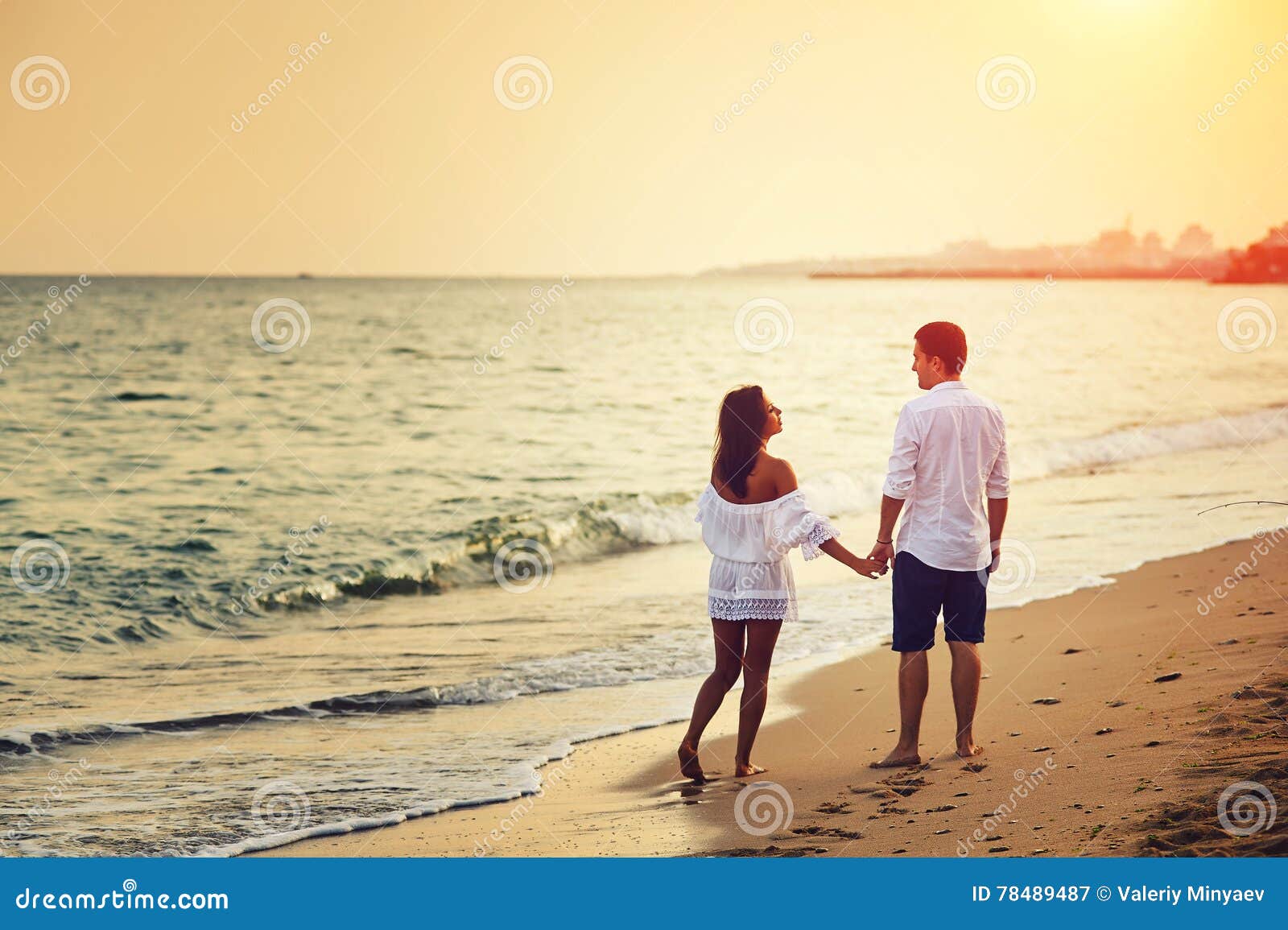 Beautiful Romantic Couple On The Sea Shore During Sunset Stock Image