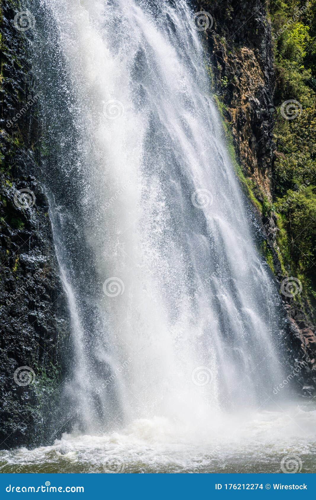 Beautiful Scenery of a Powerful Waterfall Flowing through a Cliff into ...