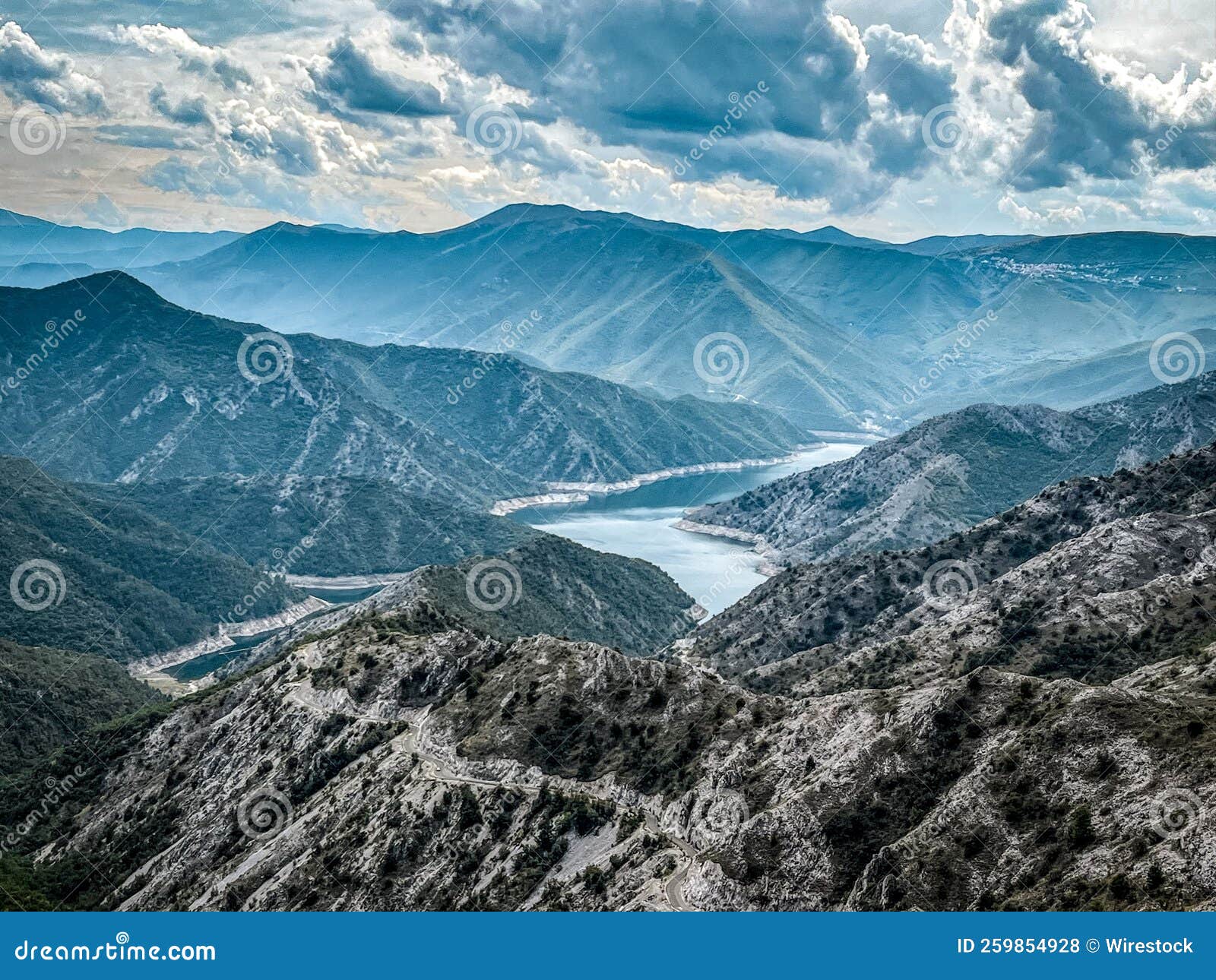 Beautiful Scenery of a River Surrounded by Mountains Under Cloudy Sky ...