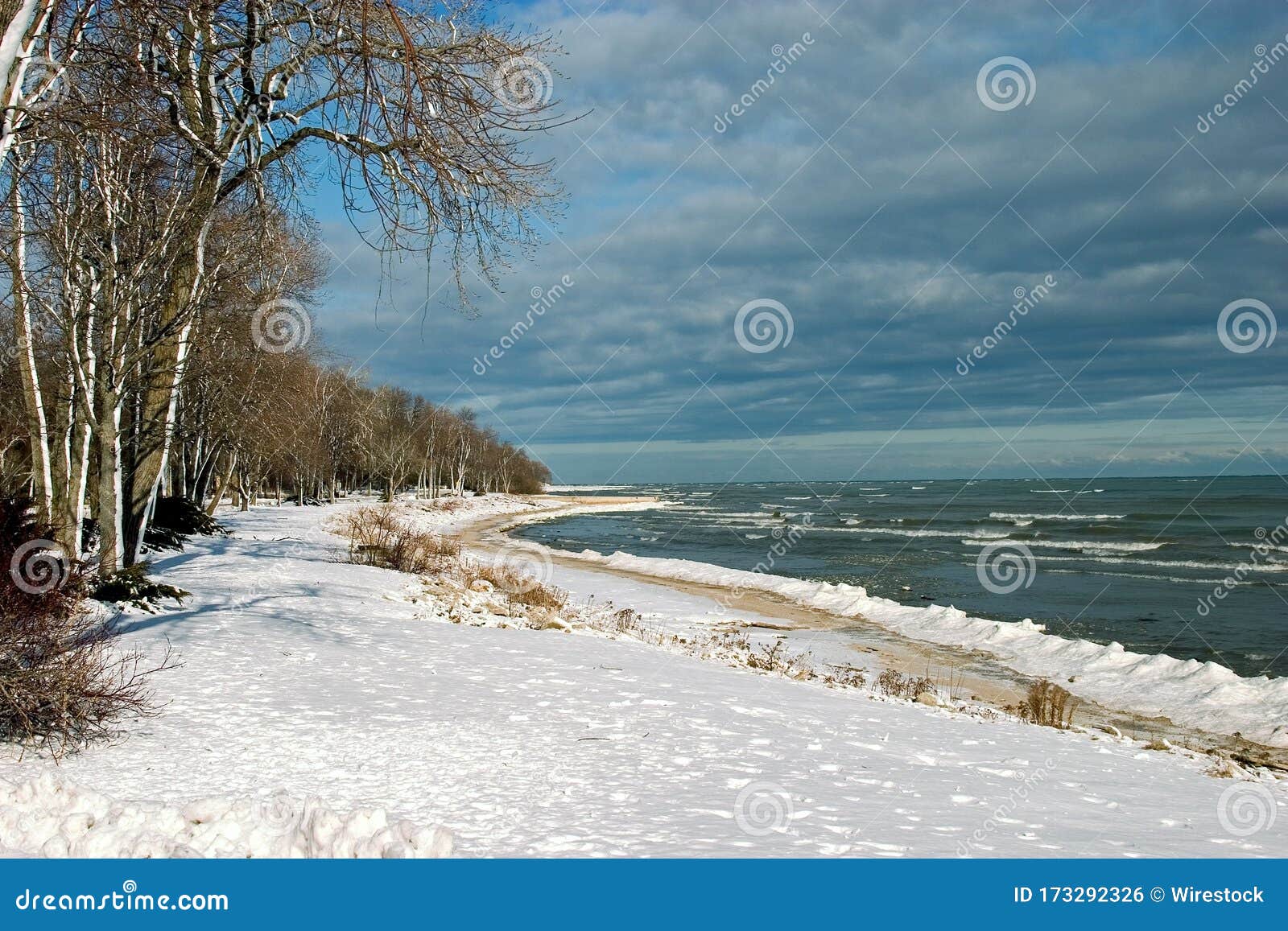 Beautiful Scenery of a Snow-covered Beach by the Sea Under a Cloudy Sky ...