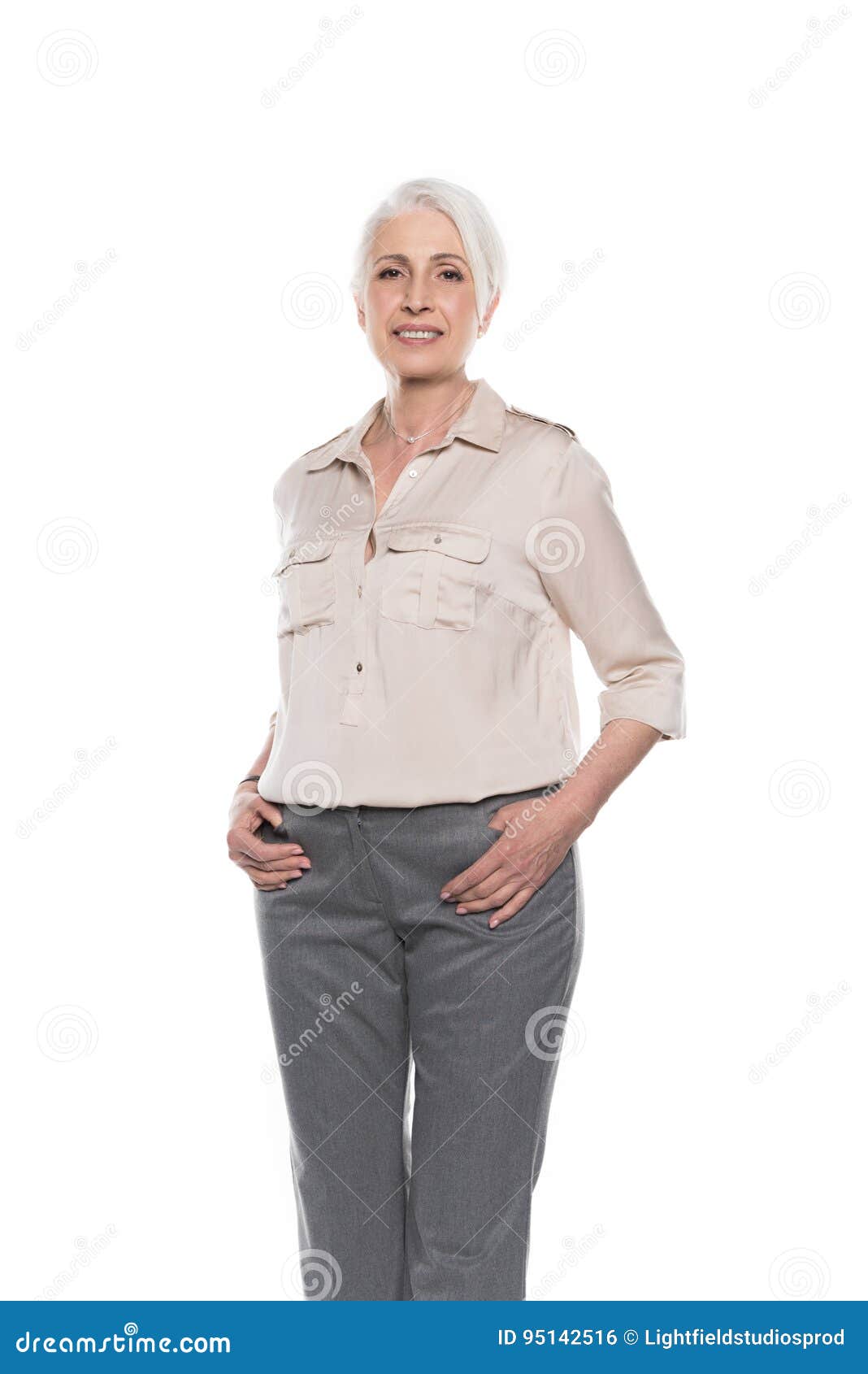 Beautiful Senior Lady Standing with Hands in Pockets and Looking at ...