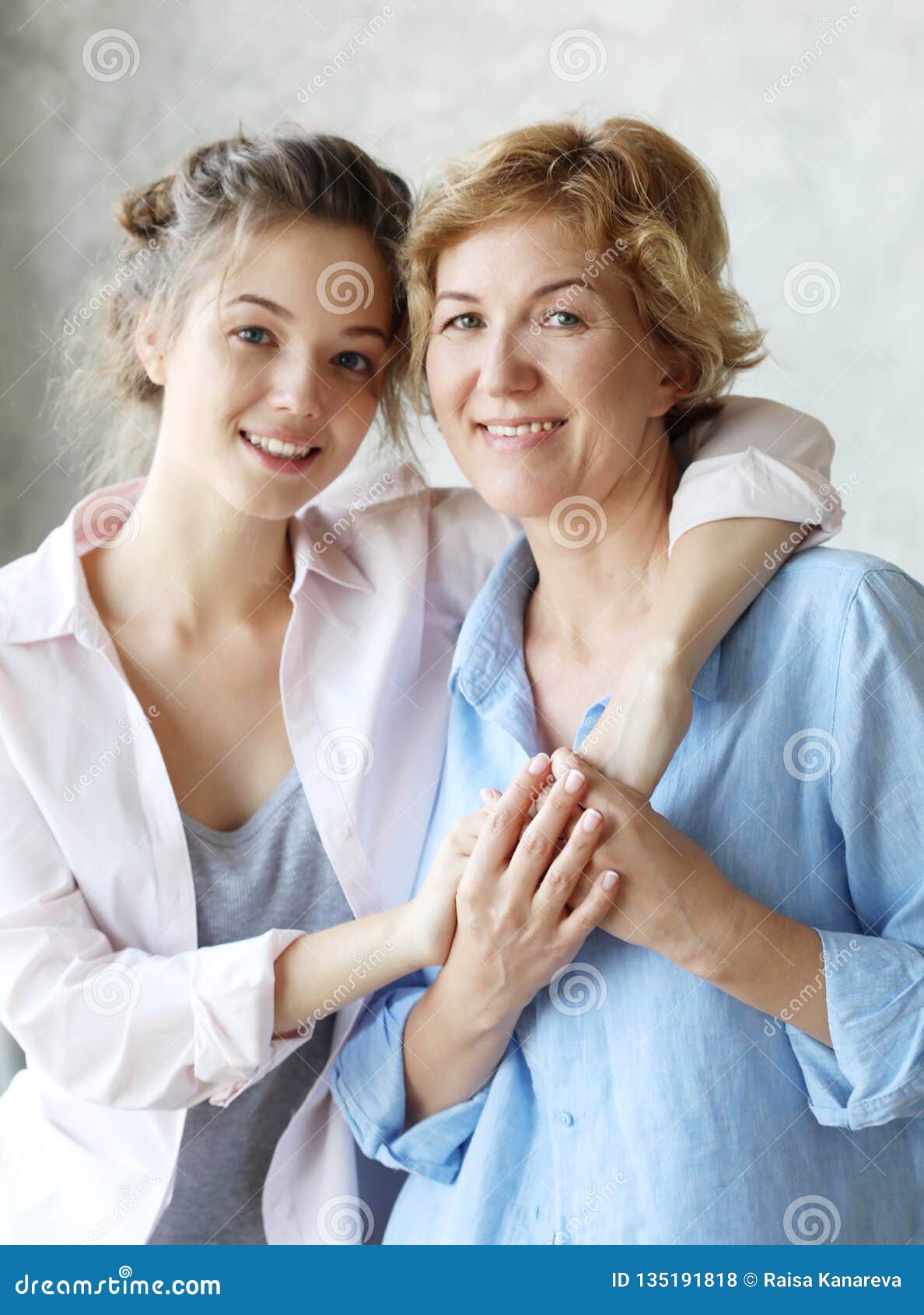 Beautiful Senior Mom And Her Adult Daughter Are Hugging Looking At