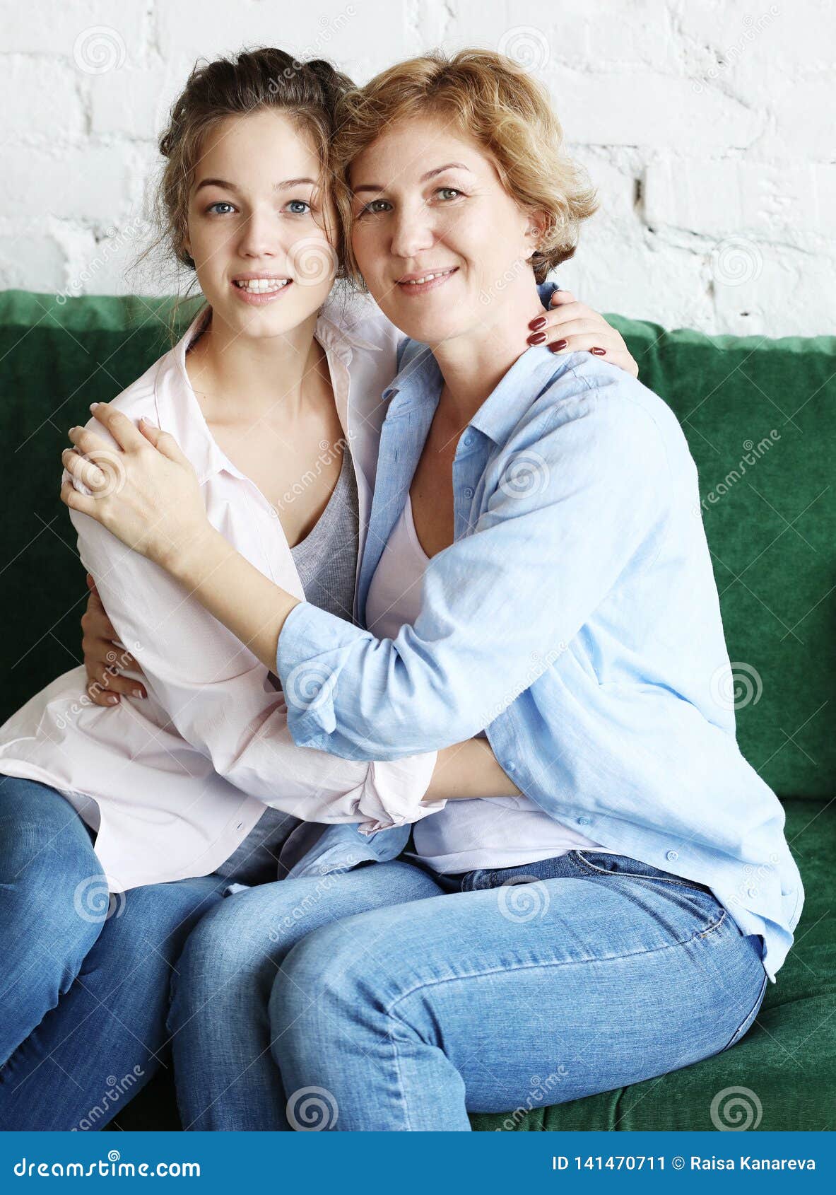 Beautiful Senior Mom And Her Adult Daughter Are Hugging Looking At
